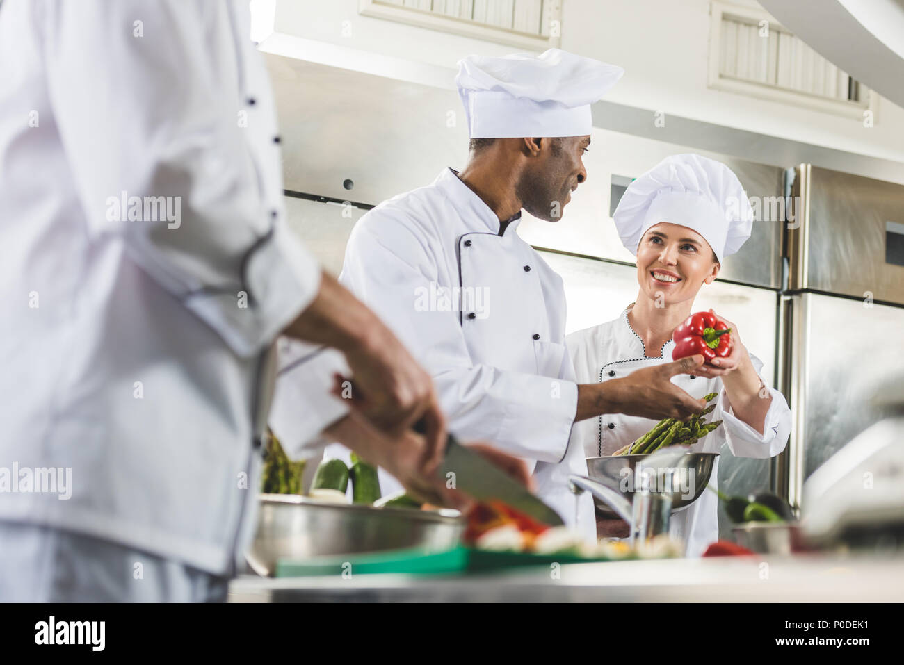 multicultural chefs at work in restaurant kitchen Stock Photo - Alamy