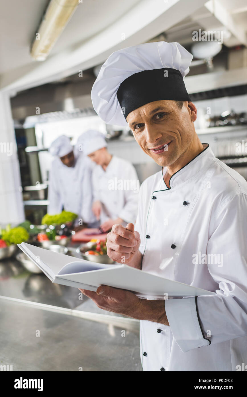Chef holding his recipe book hi-res stock photography and images - Alamy