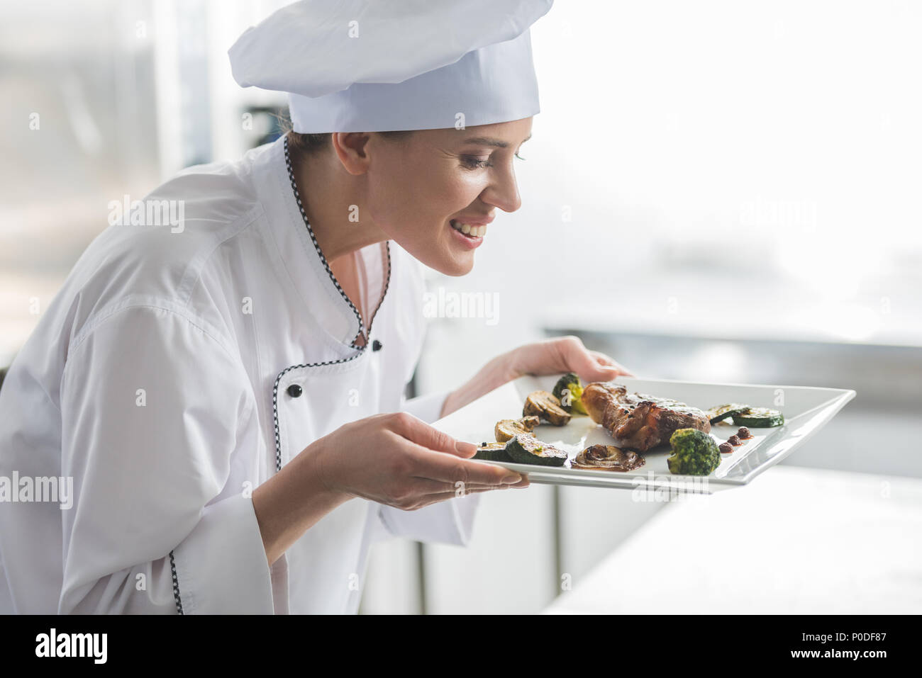 attractive chef sniffing cooked steak at restaurant kitchen Stock Photo ...