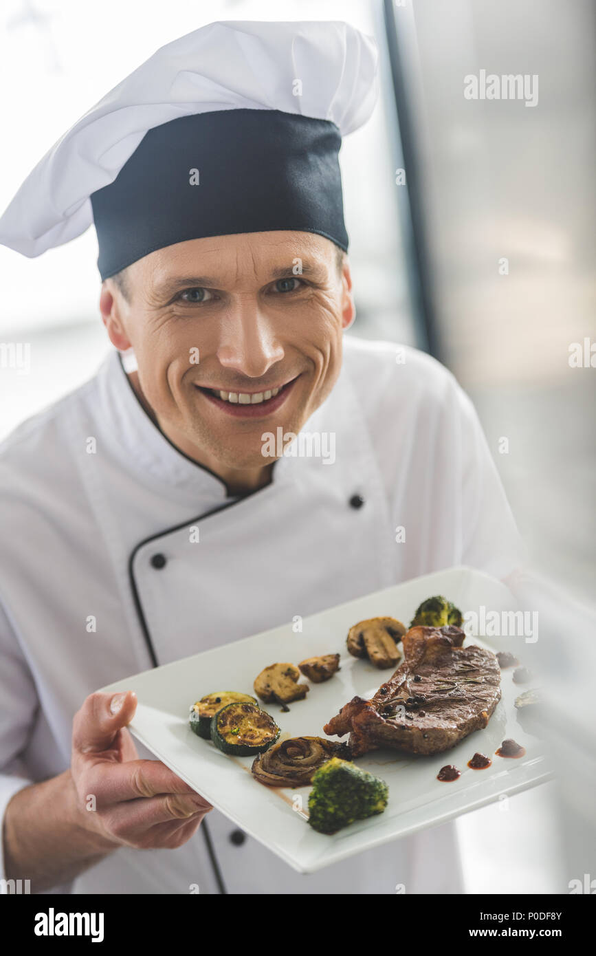 Handsome chef looking meal hi-res stock photography and images - Alamy
