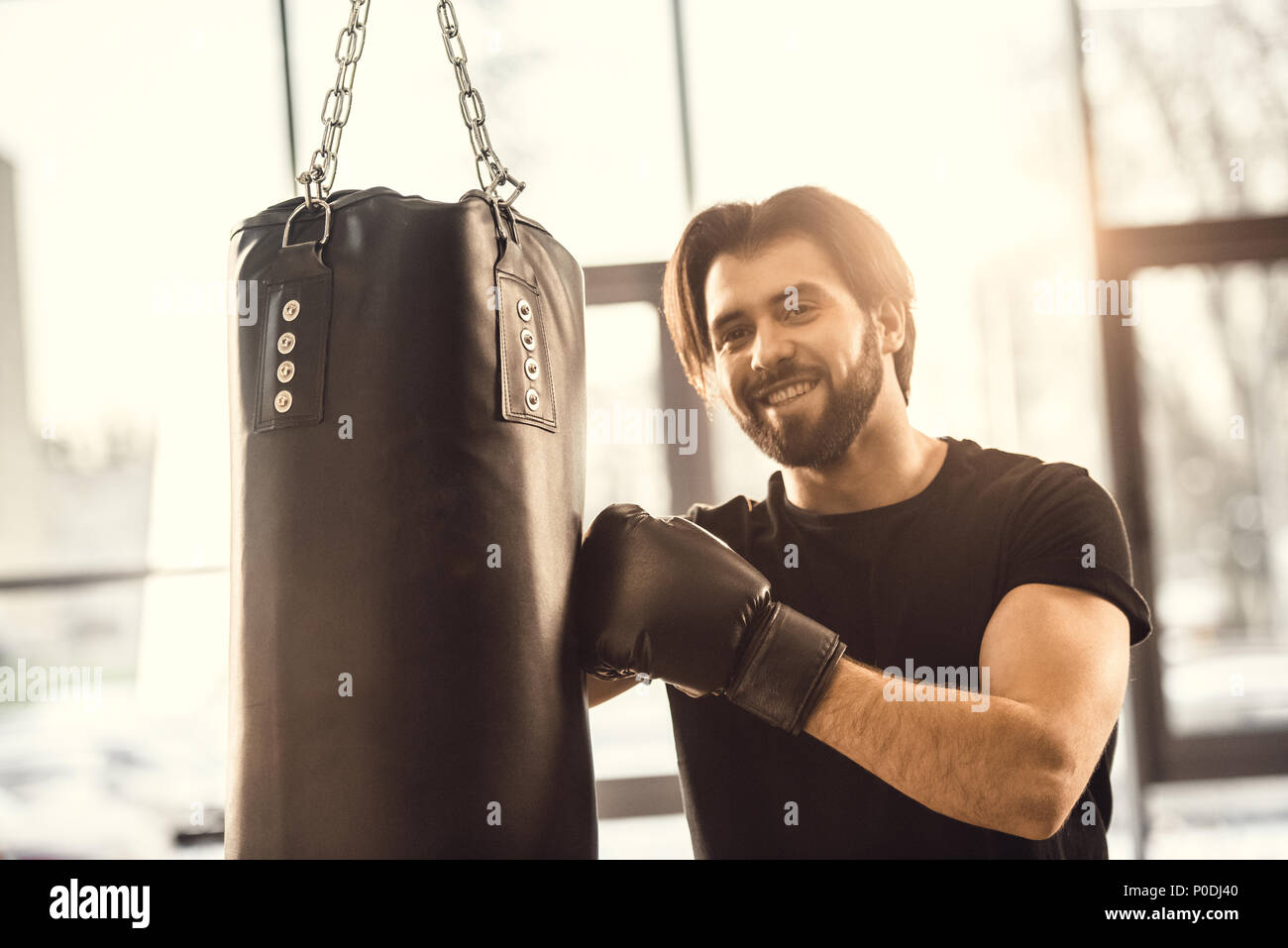 handsome young man boxing and smiling at camera in gym Stock Photo - Alamy