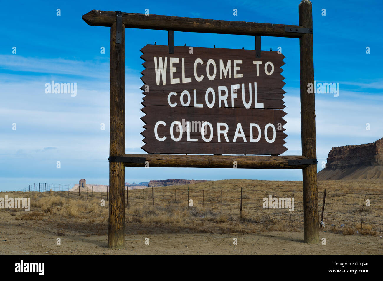 Welcome to Colorado sign wiht blue sky and mountains in the background ...