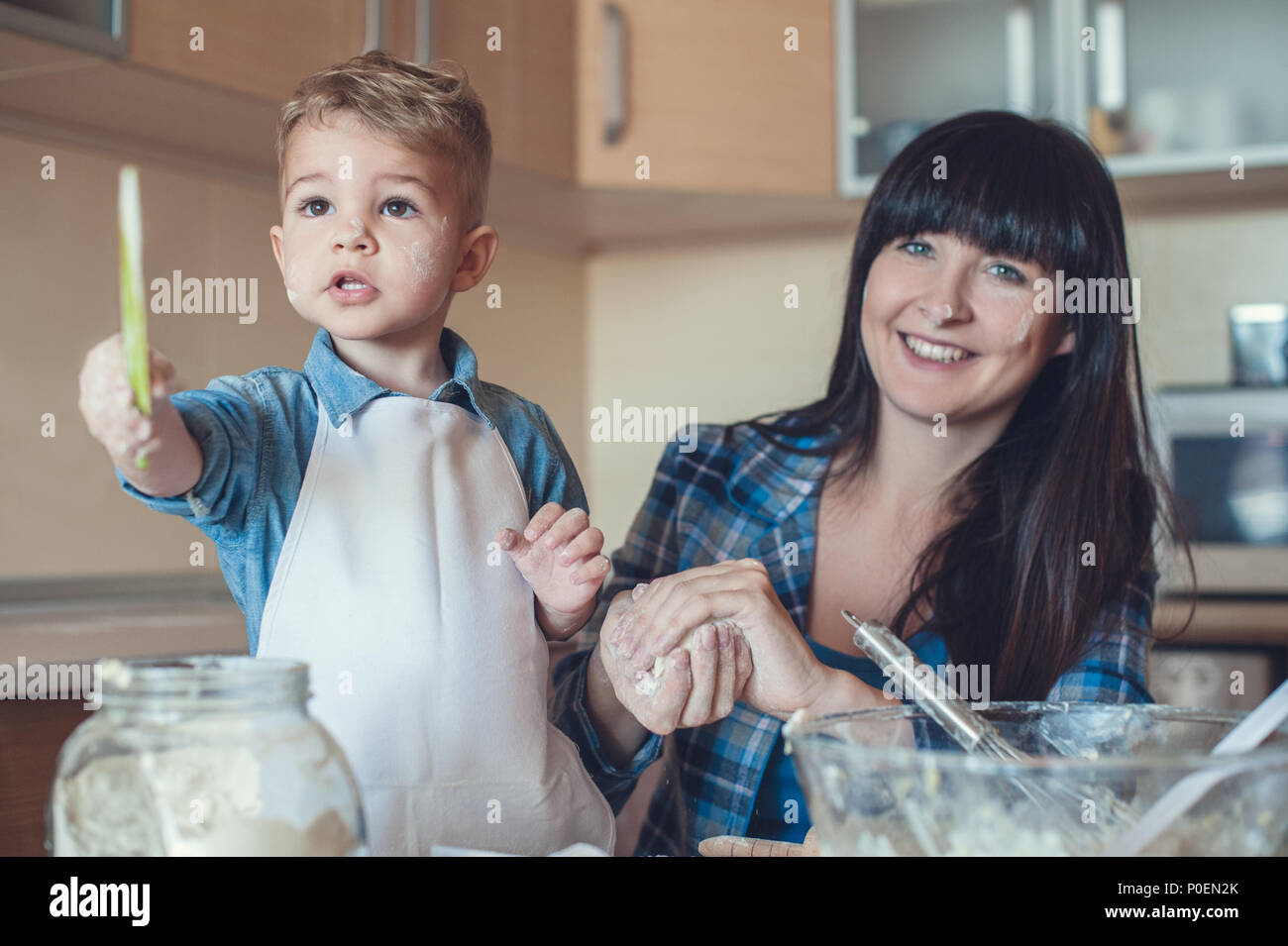 adorable son pointing on something in kitchen Stock Photo - Alamy
