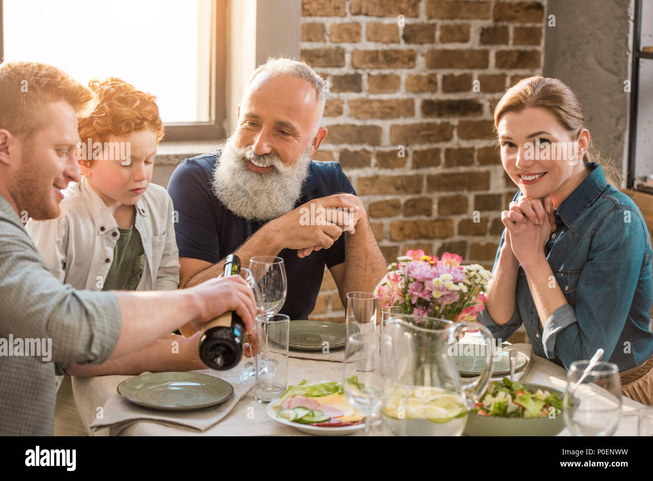 happy family having conversation during family dinner at home Stock ...