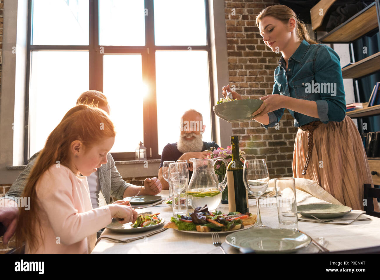 happy family having conversation during family dinner at home Stock ...