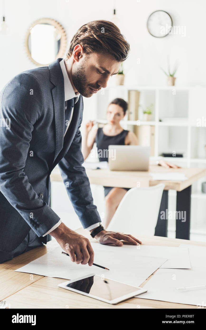 Business a man standing over a desk hi-res stock photography and images ...