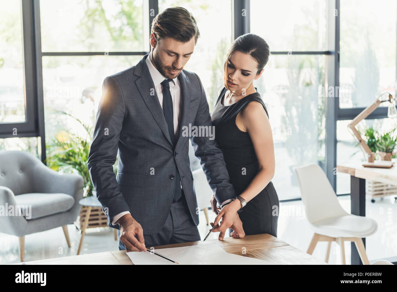 Business a man standing over a desk hi-res stock photography and images ...