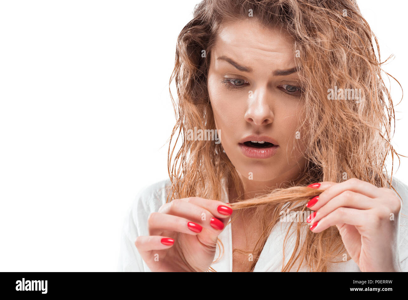shocked blonde woman looking on split ends isolated on white Stock ...