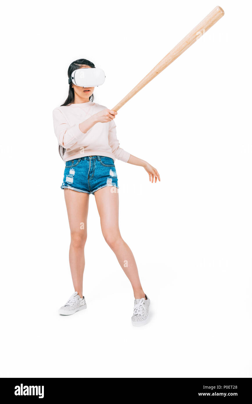 full length view of young asian woman in virtual reality headset ...