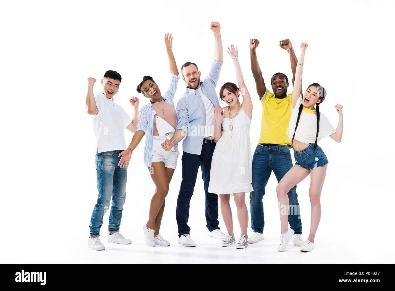 group of happy young multiethnic people triumphing and smiling at ...