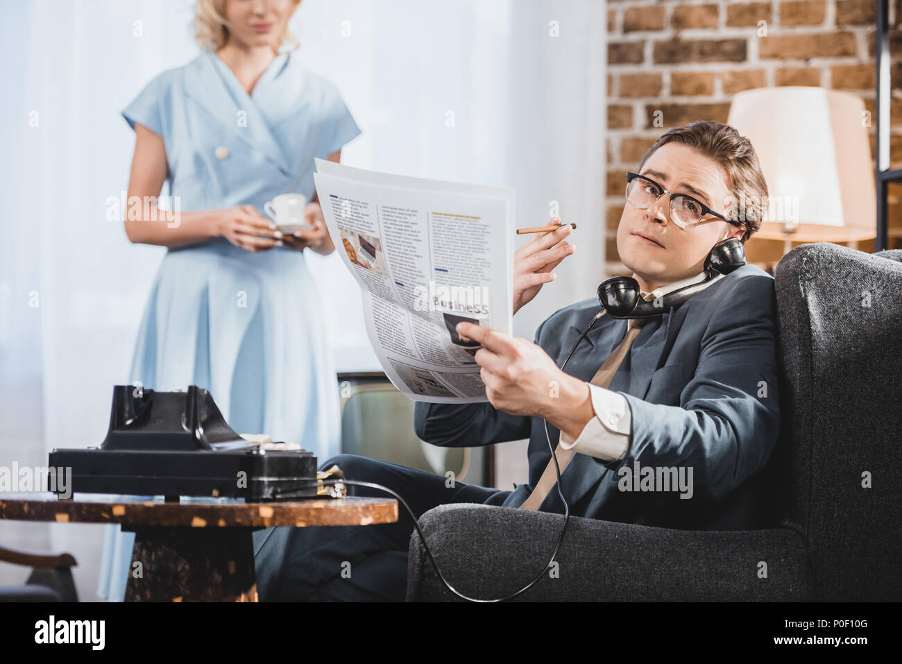 Woman smoking while reading newspaper hi-res stock photography and ...