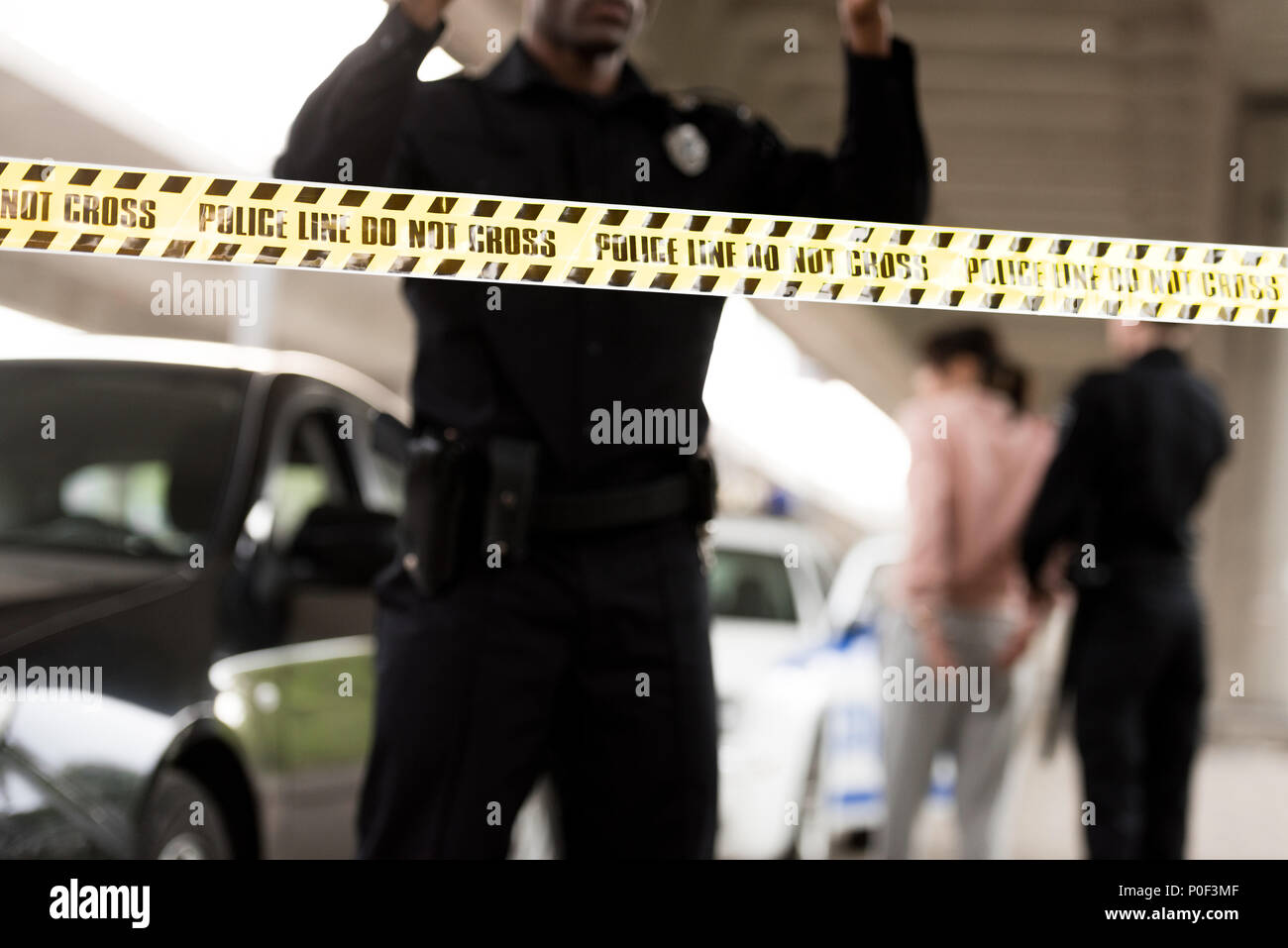 closeup shot of cross line and policeman standing behind Stock Photo ...
