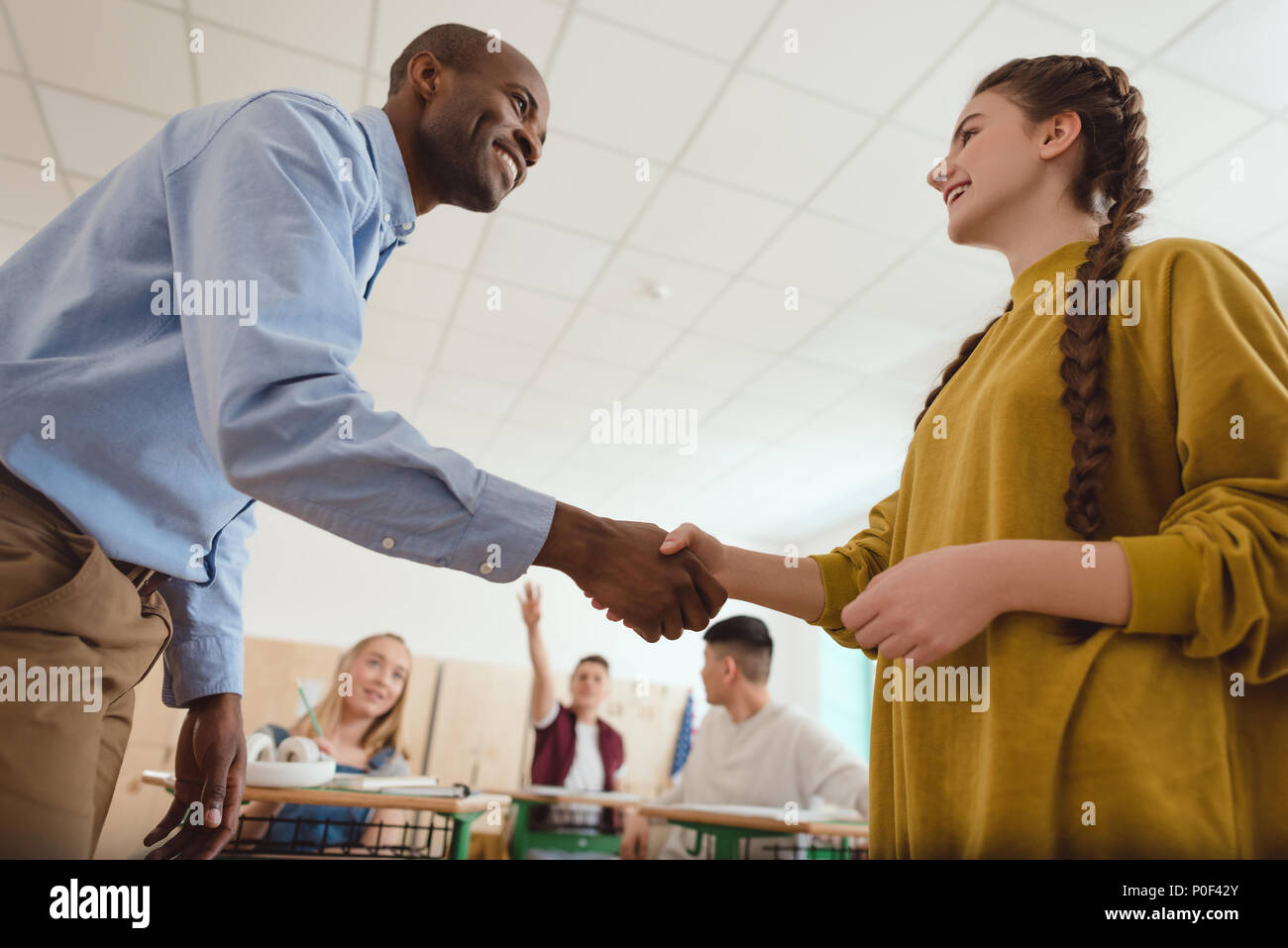 Male female shaking hands students hi-res stock photography and images ...