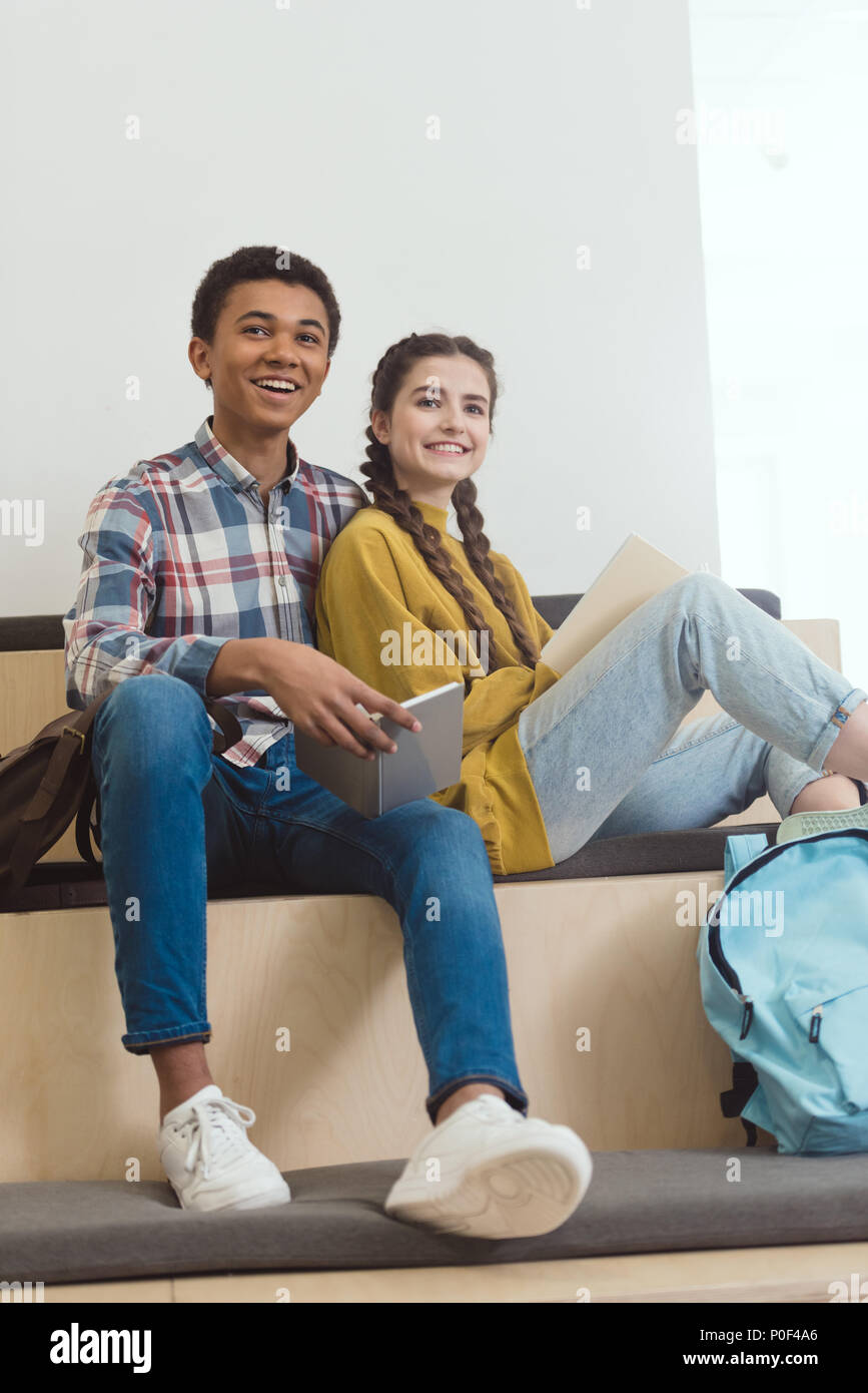 high school students couple sitting together at school corridor Stock ...