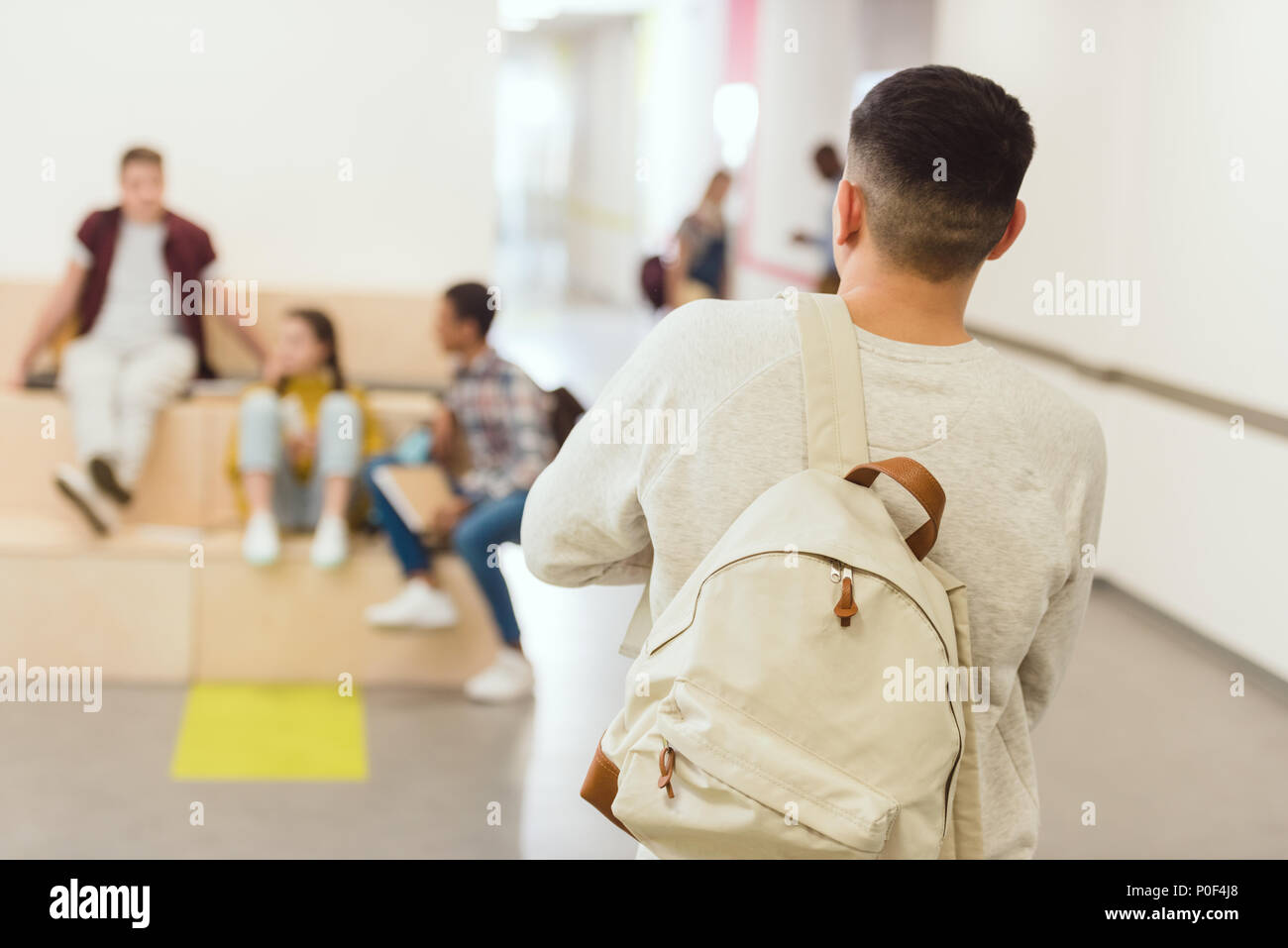 rear view of high school student standing at school corridor Stock ...