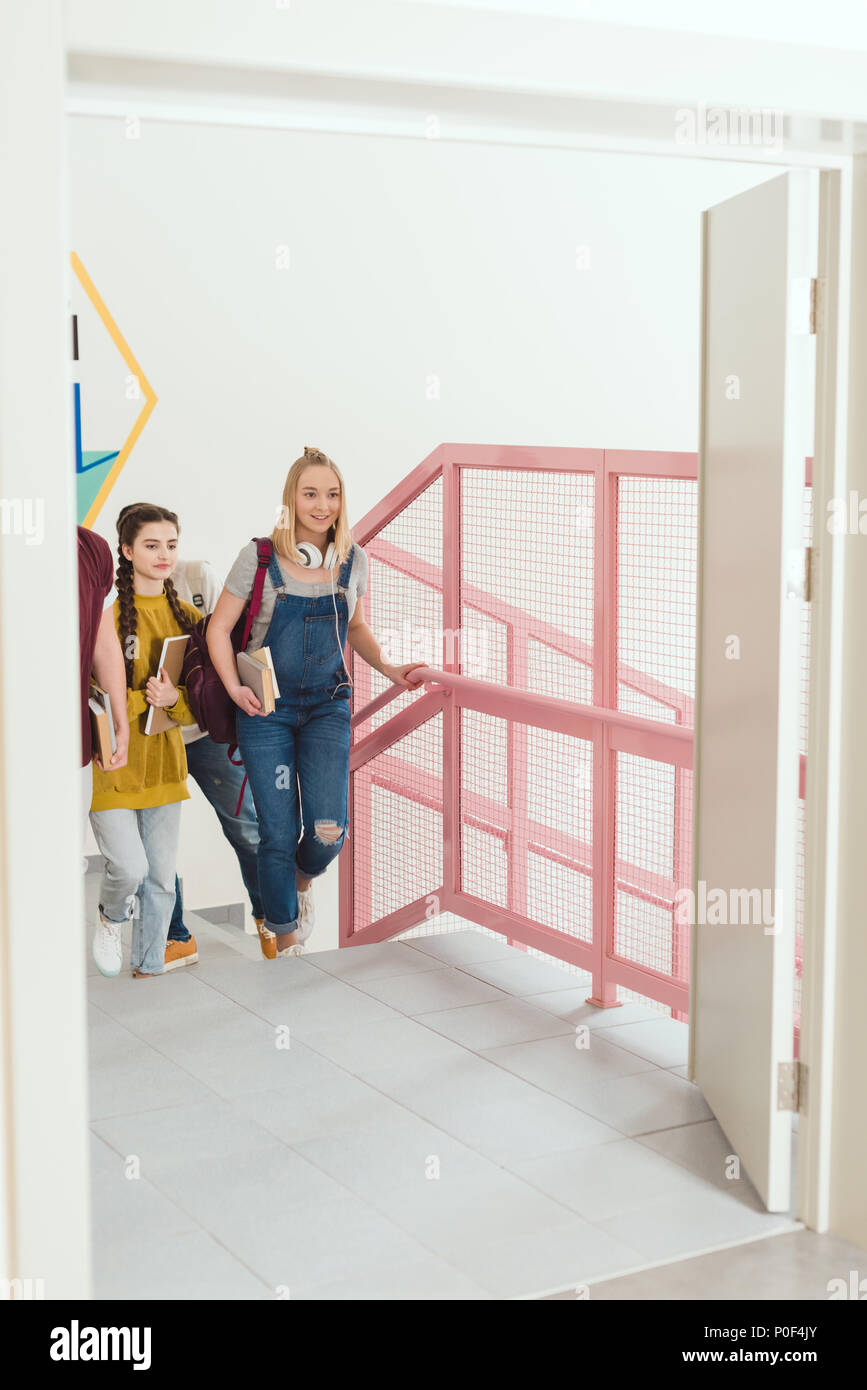teenage schoolgirls walking by school corridor Stock Photo - Alamy