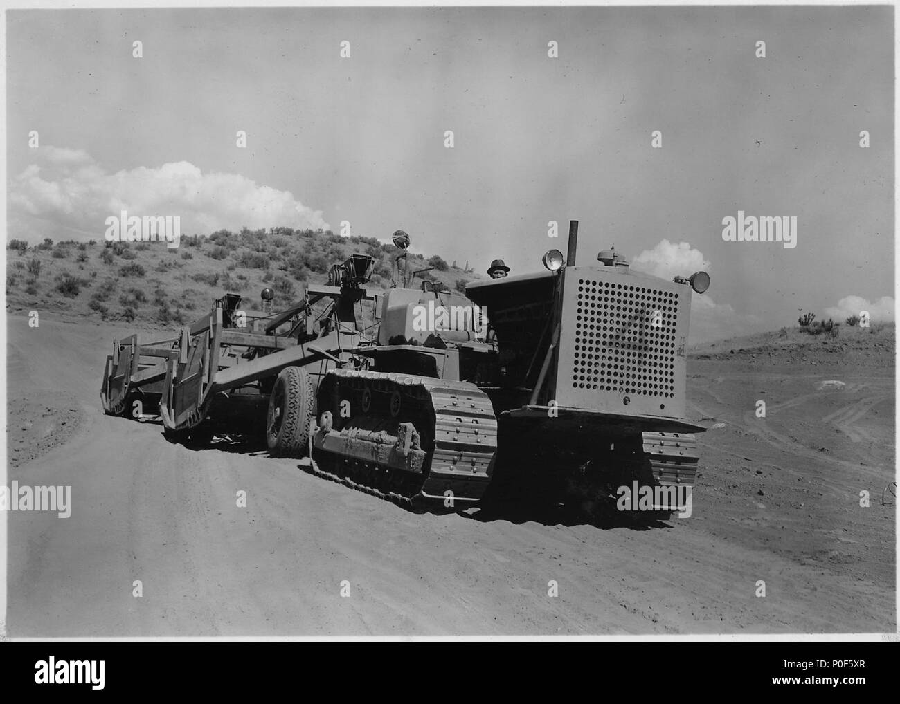 Tractor powered scrapers removing top soil from gravel pit Stock Photo ...