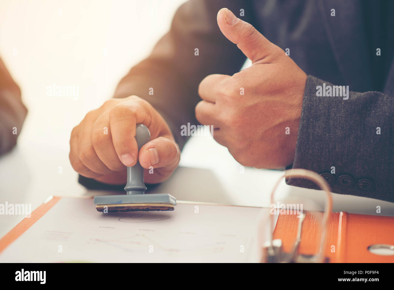 Business hand putting stamp on a document, close up Stock Photo - Alamy
