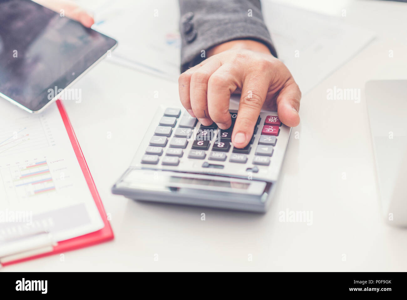 Businessman using a calculator to calculate the numbers. Accounting ...