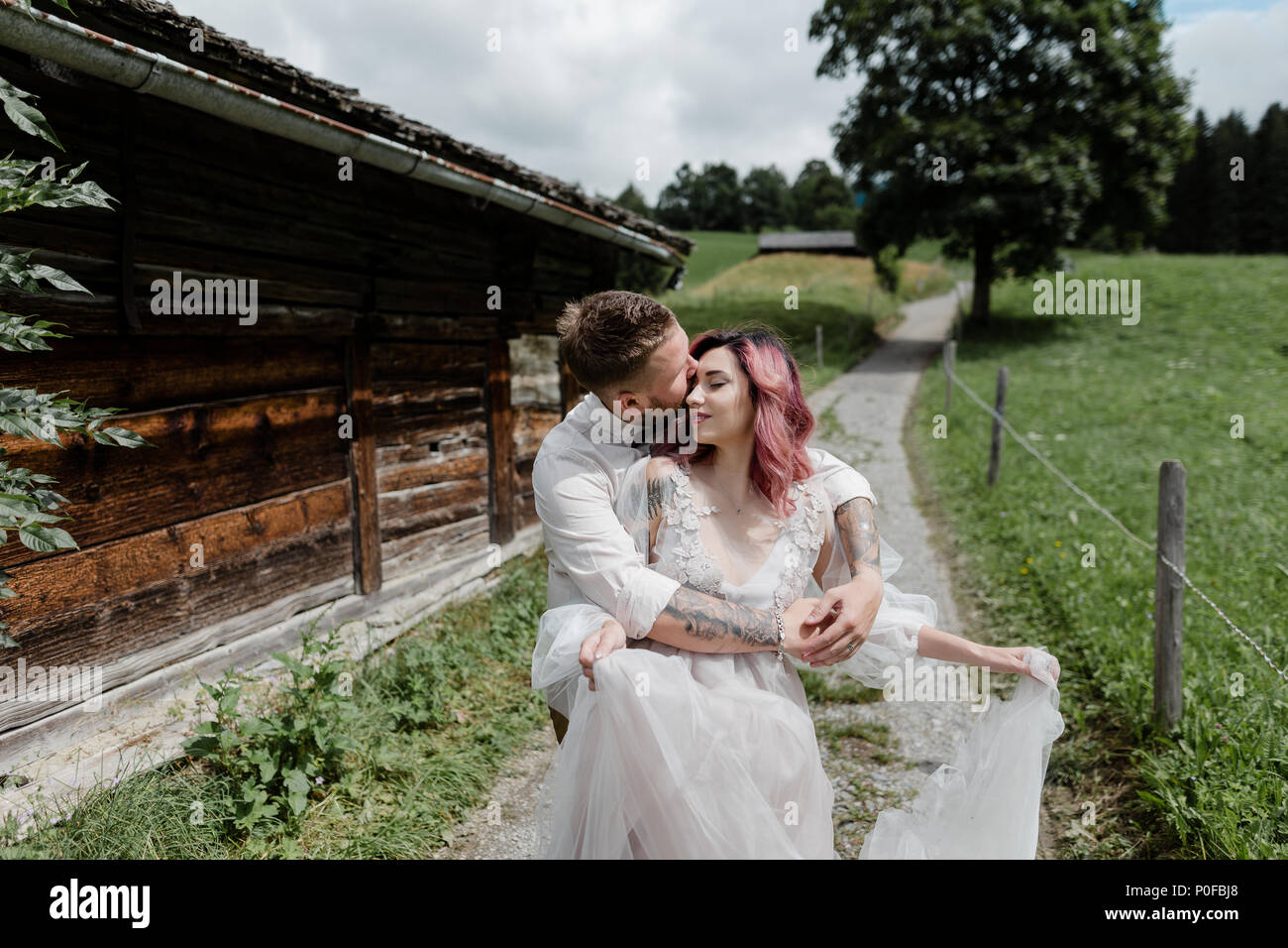 handsome groom kissing and hugging bride in wedding dress, Alps Stock ...