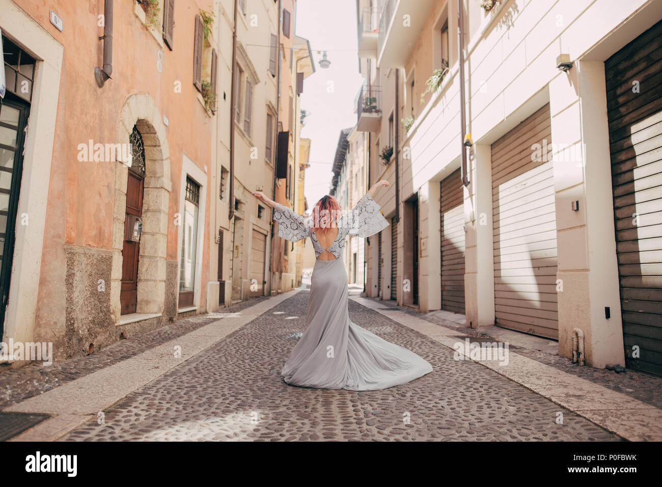 back view of elegant girl in glamorous dress on street of Verona Stock ...