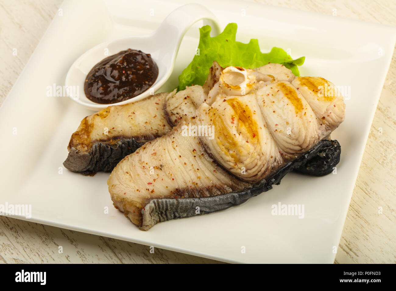 Grilled shark steak with pepper sauce and salad leaves Stock Photo - Alamy
