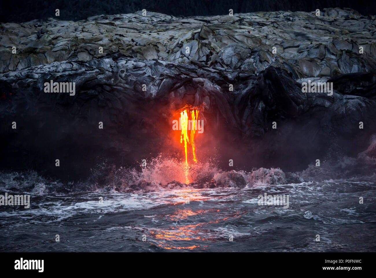 Hot molten lava flowing into the ocean on the Big Island of Hawaii ...