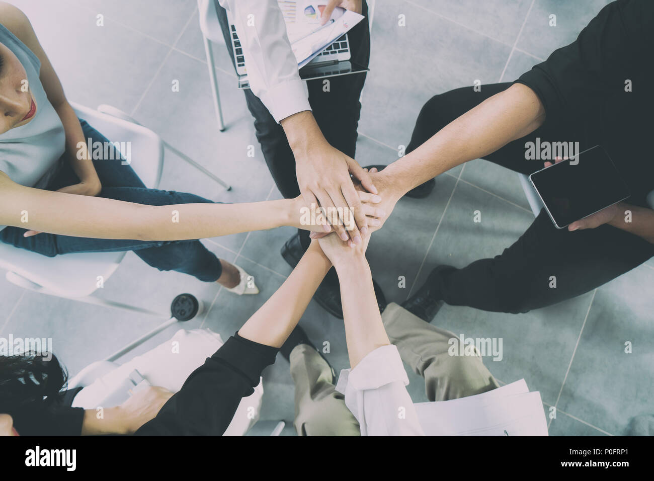 Close up top view of young business people putting their hands together. Stack of hands. Unity ...