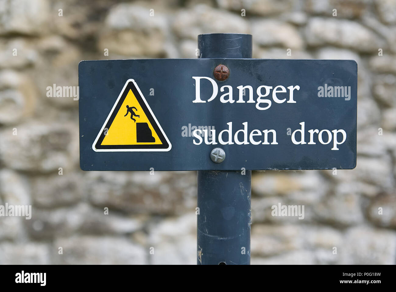 Danger sudden drop metal sign yellow warning triangle with symbol of ...