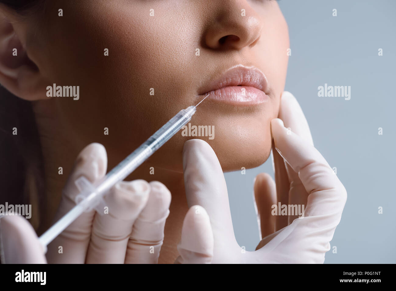 Portrait of attractive woman getting injection isolated on white Stock ...