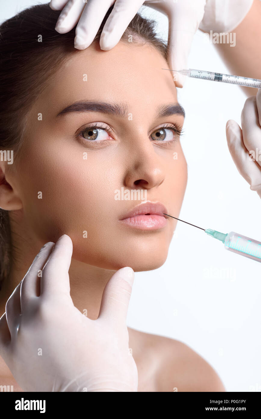 Portrait of attractive woman getting injection isolated on white Stock ...