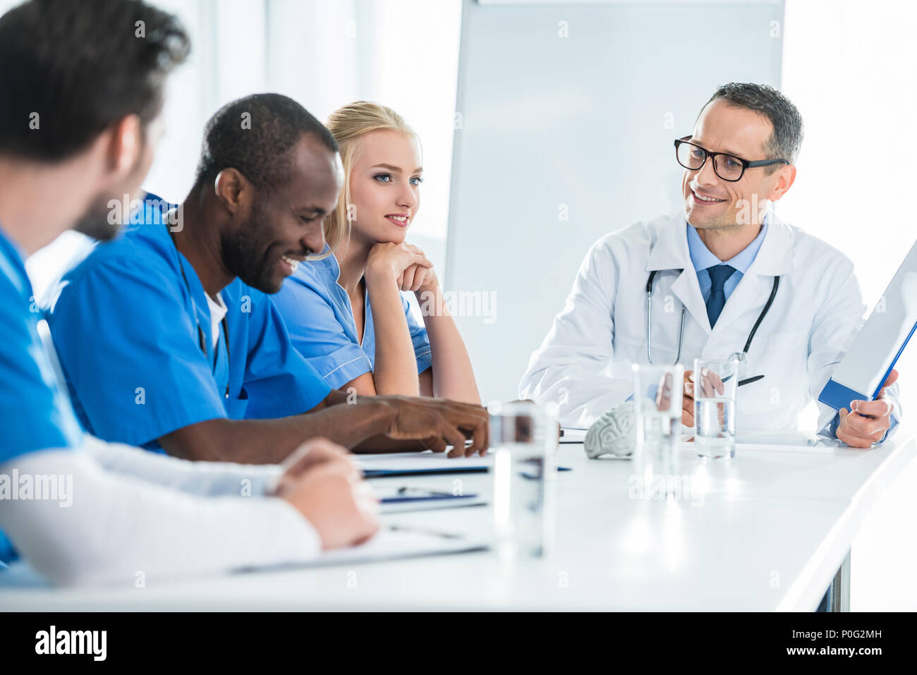 Multiethnic doctors having medical conference hi-res stock photography ...