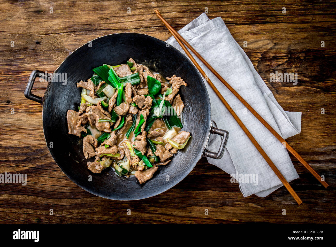 Traditional chinese mongolian beef stir fry in chinese cast iron wok ...