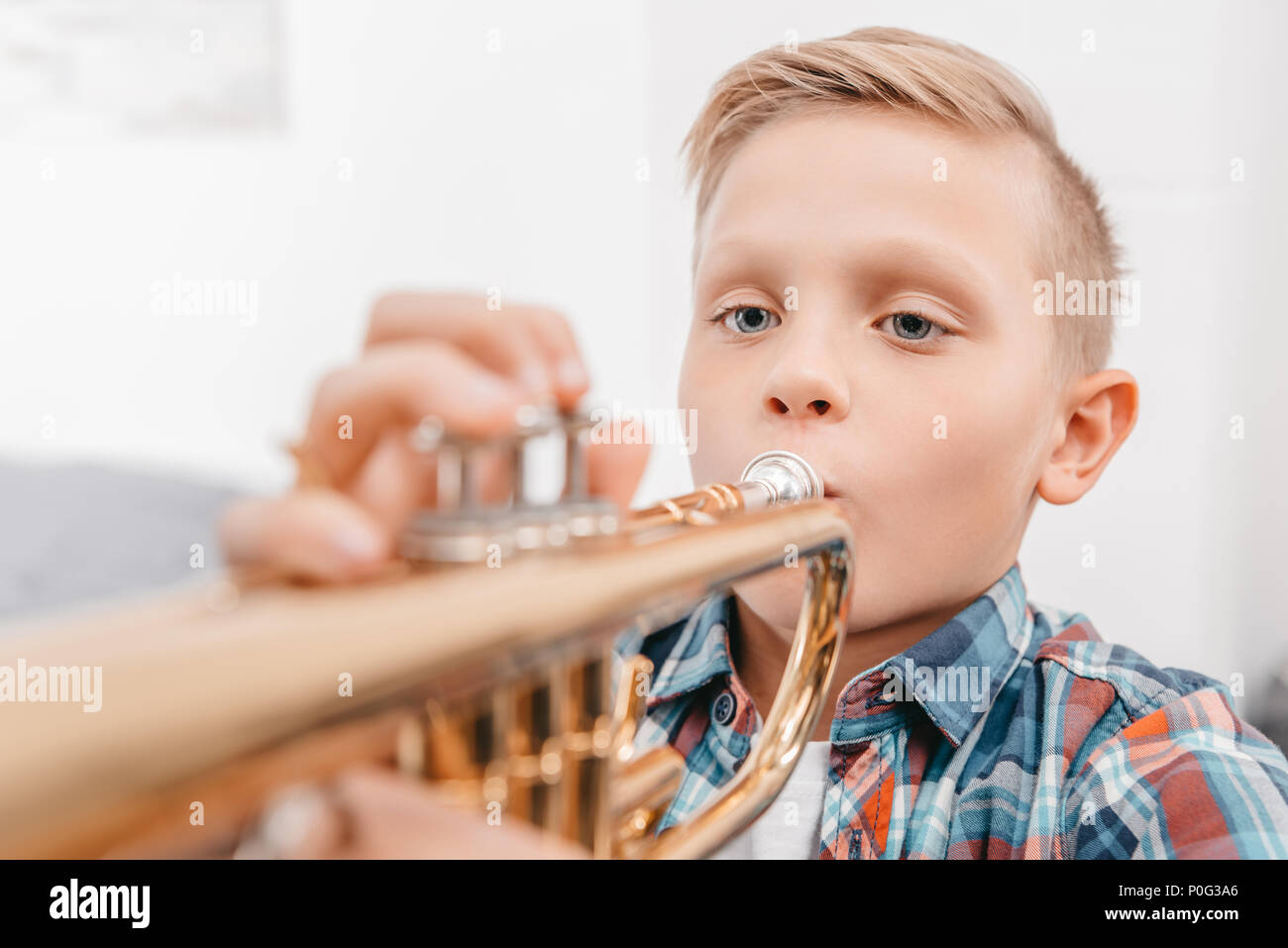Boy playing trumpet hi-res stock photography and images - Alamy
