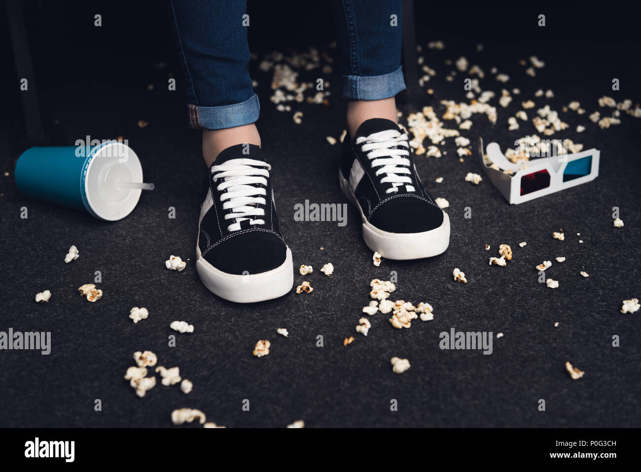 low section of female legs on messy floor in movie theater Stock Photo ...