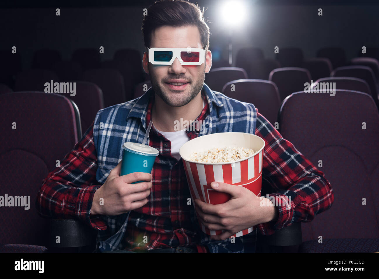 handsome man in 3d glasses with popcorn and soda watching movie in cinema Stock Photo - Alamy