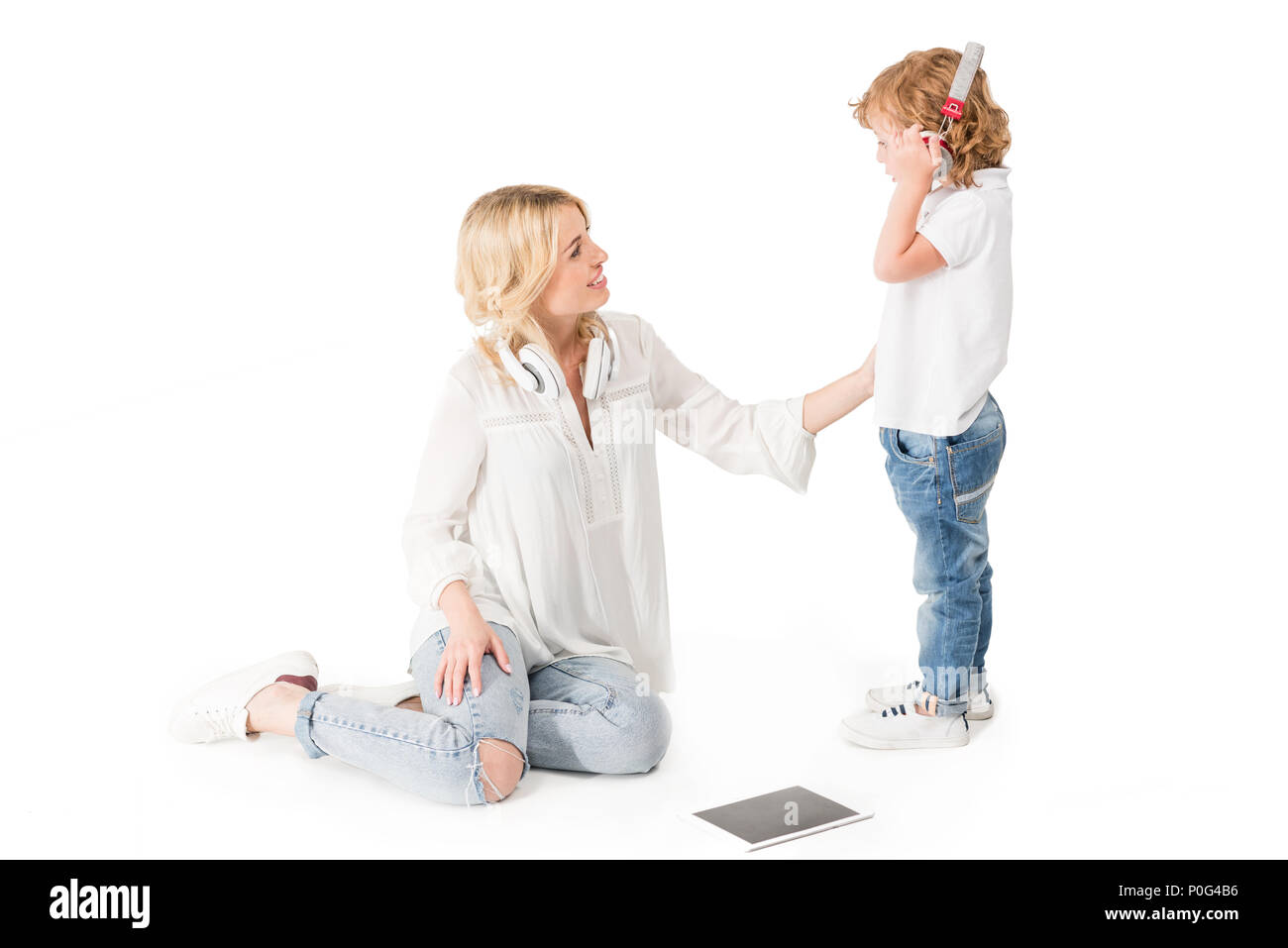 little boy in headphones having conversation with mother isolated on ...