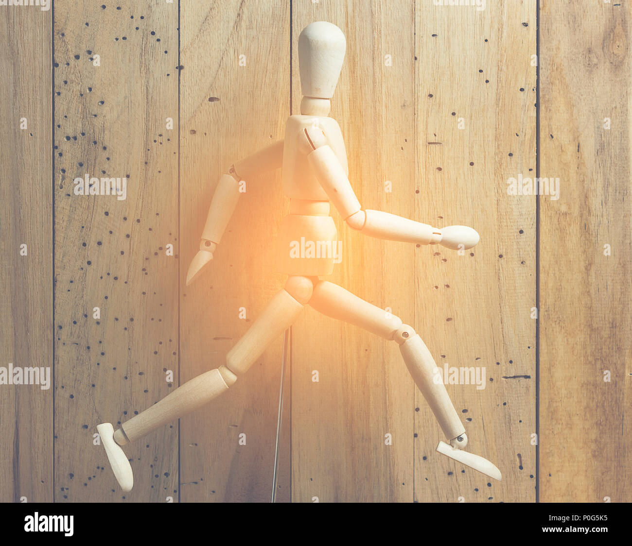 Wooden puppet on wood background, vintage filter image Stock Photo - Alamy