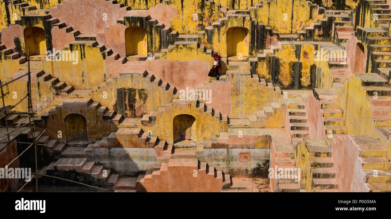 A woman in traditional dress visit the ancient Indian deep well with ...