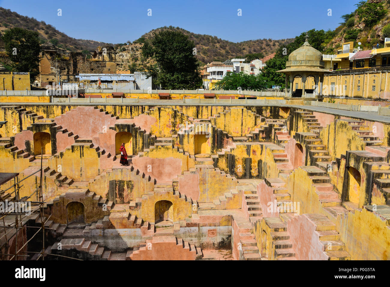 A woman in traditional dress visit the ancient Indian deep well with ...