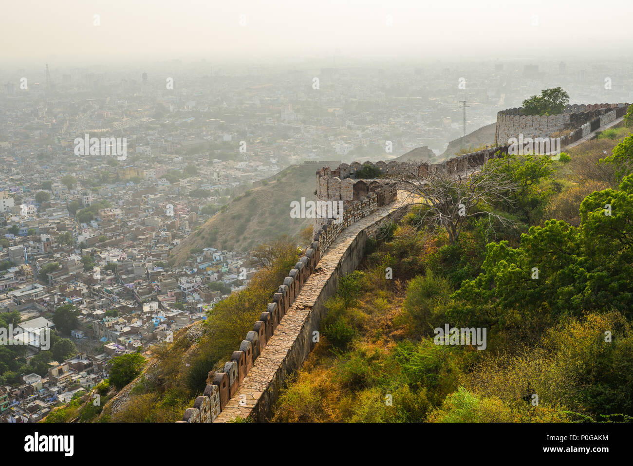 Stone wall of ancient fort on mountain with Jaipur cityscape, India ...