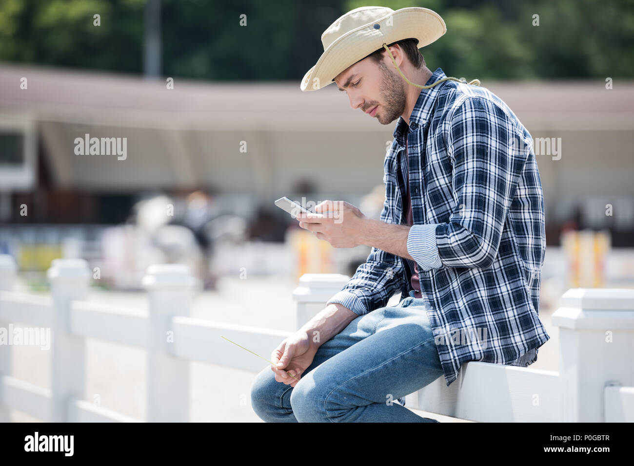 Cowboy sitting on fence hi-res stock photography and images - Alamy