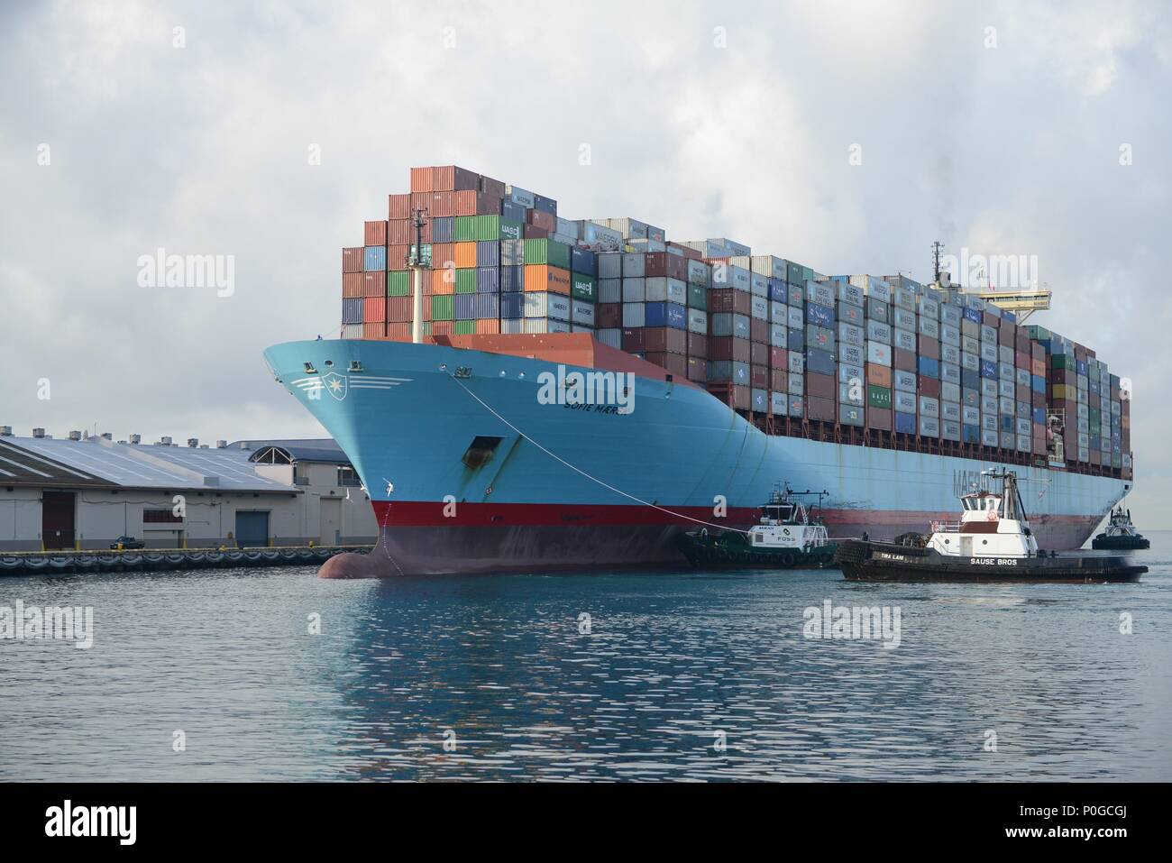 The Sofie Maersk, a container ship, gets escorted by tugs into Honolulu Harbor, March 27, 2018 ...