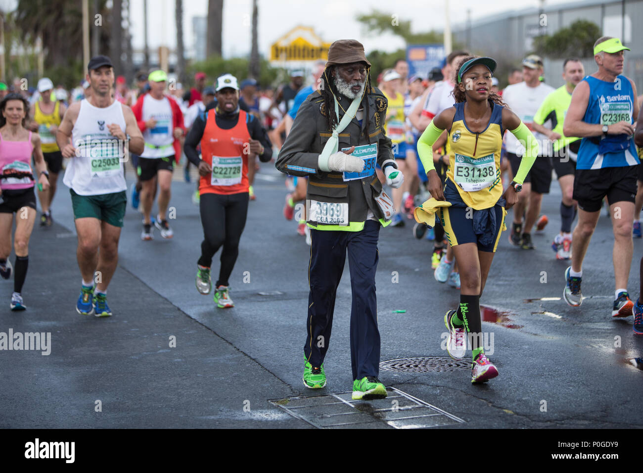 Old Man in Uniform Running a marathon with a broken arm in a brace ...