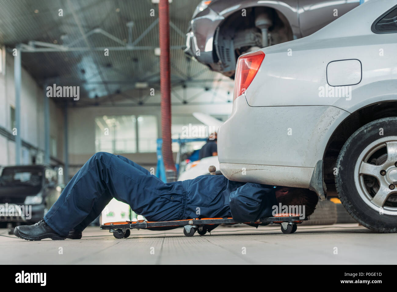 Man lying under car hi-res stock photography and images - Alamy