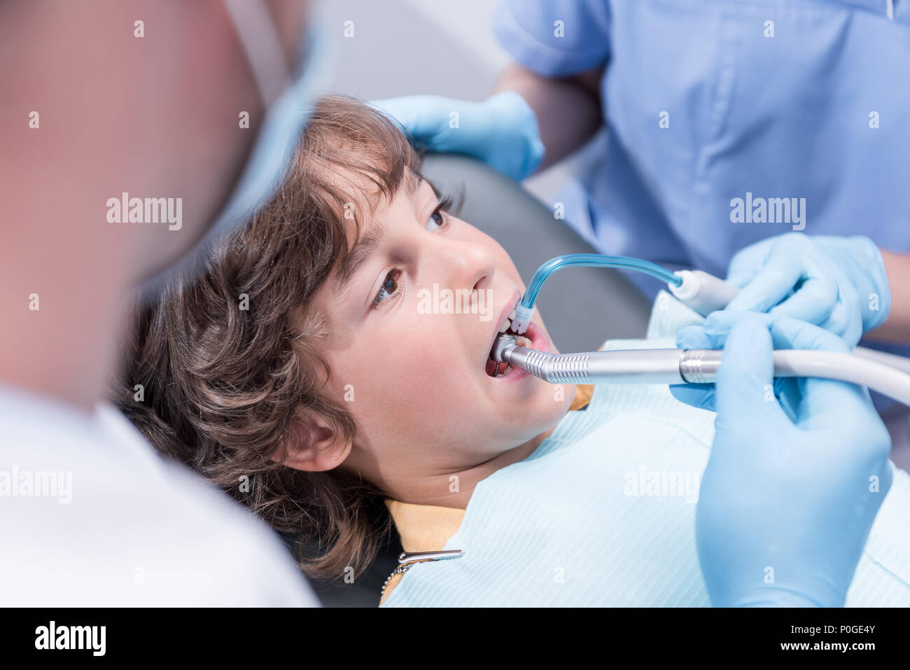 cropped shot of dentists treating teeth of boy in dental hospital Stock ...