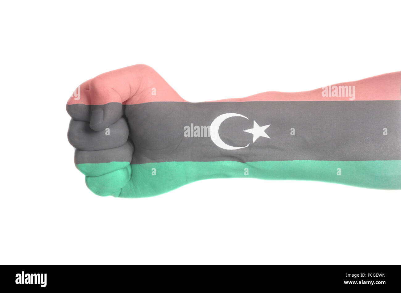 Flag of Libya on male hand with clenched fist isolated on a white ...