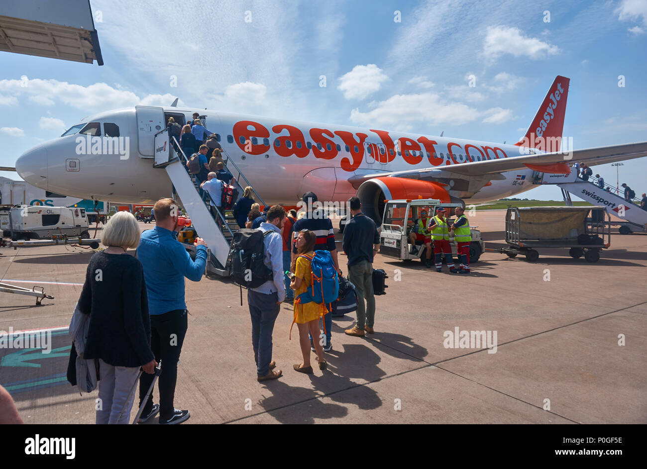 Passenger queuing and boarding the Easy jet aircraft on Bristol airport ...