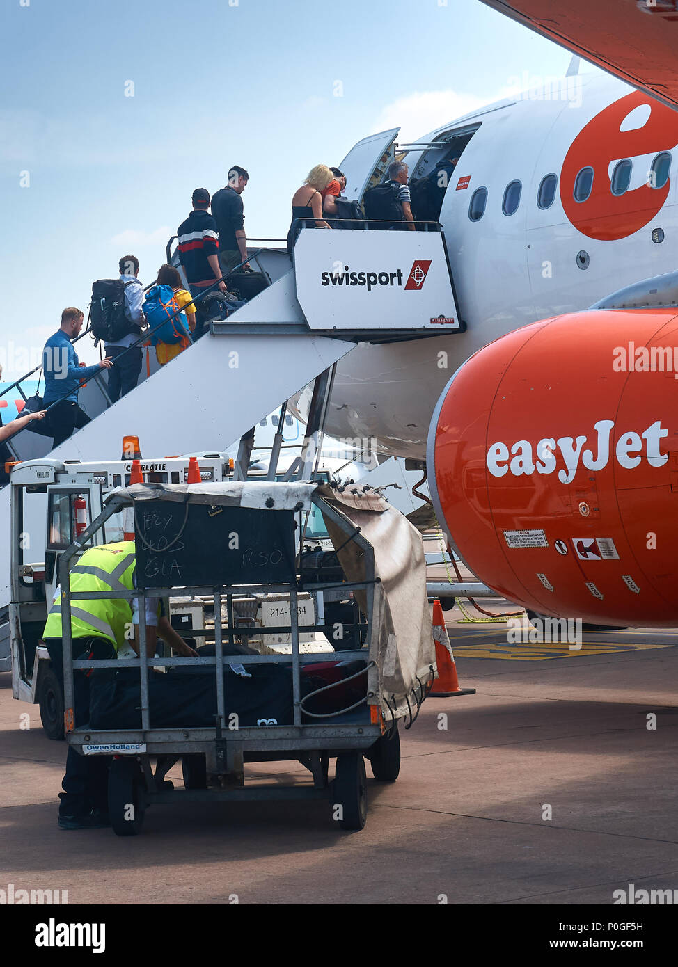 Passenger queuing and boarding the Easy jet aircraft on Bristol airport ...