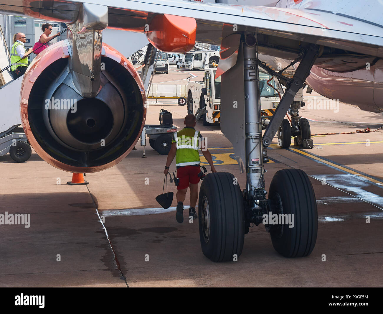 Passenger queuing and boarding the Easy jet aircraft on Bristol airport ...